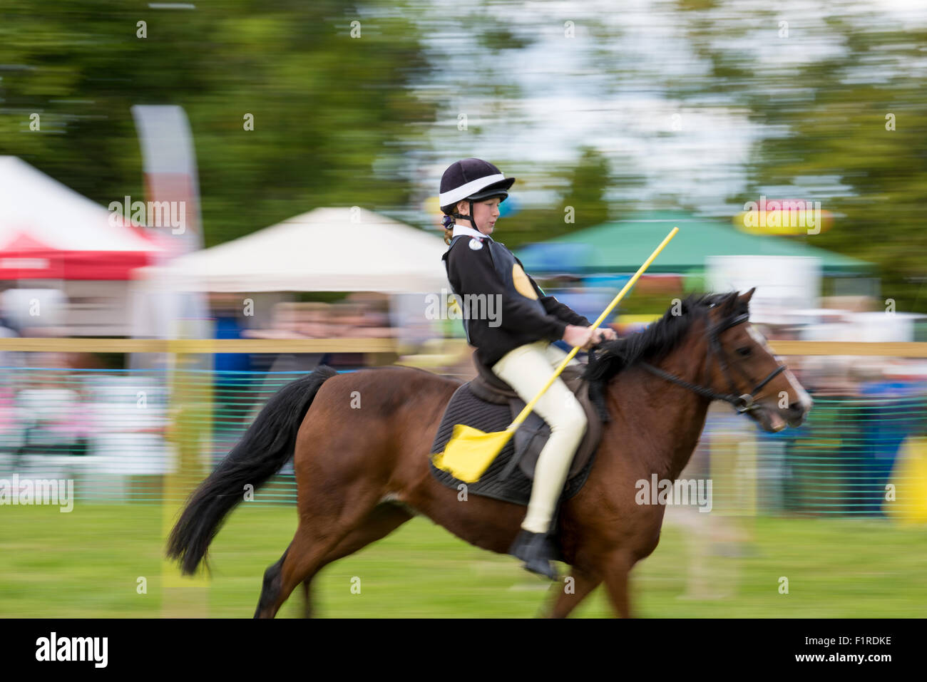 A young girl riding her pony in a competition at The Beckbury Show 2015 ...