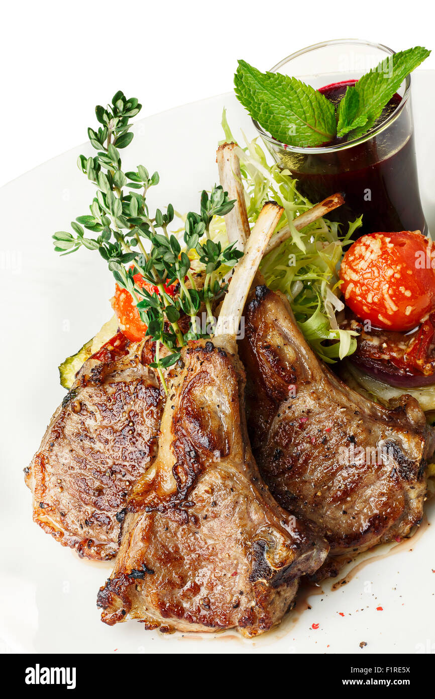 Fried lamb rack with vegetable garnish. Lamb chop dinner Stock Photo ...