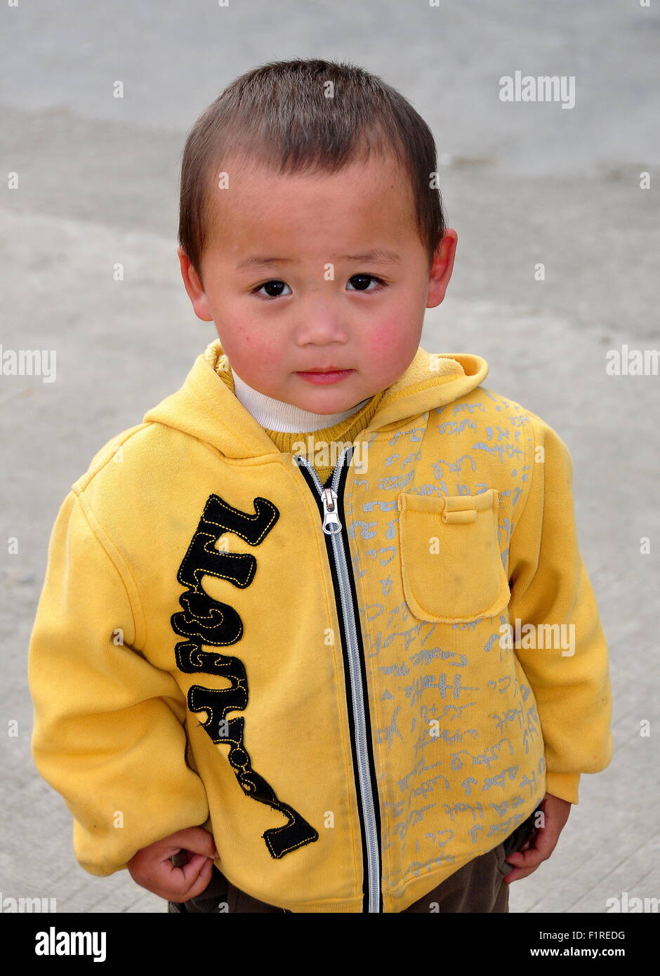 Pengzhou, China: Little Chinese boy wearing a yellow zippered sweater ...