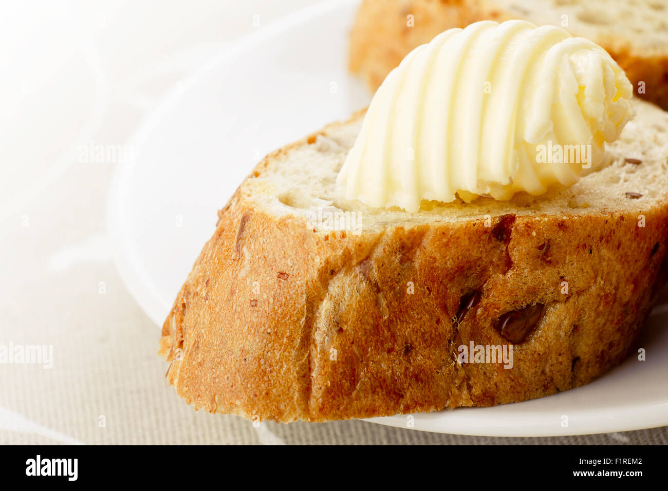 Butter curl on a slice of bread. Healthy breakfast Stock Photo - Alamy