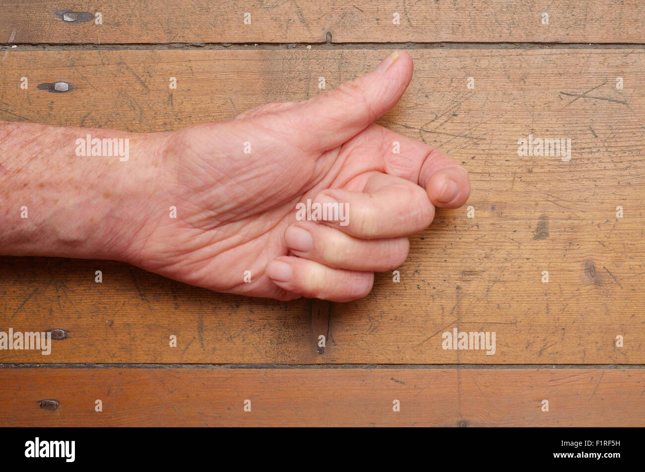 Old man's hand gesturing on wooden backdrop Stock Photo - Alamy