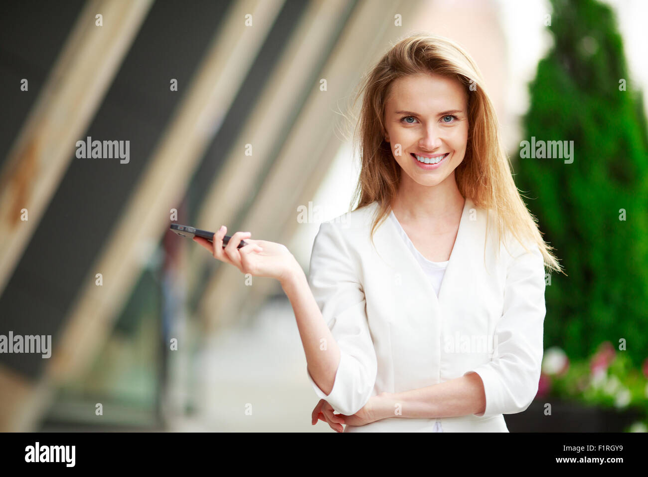 Beautiful casual woman with cell phone Stock Photo - Alamy
