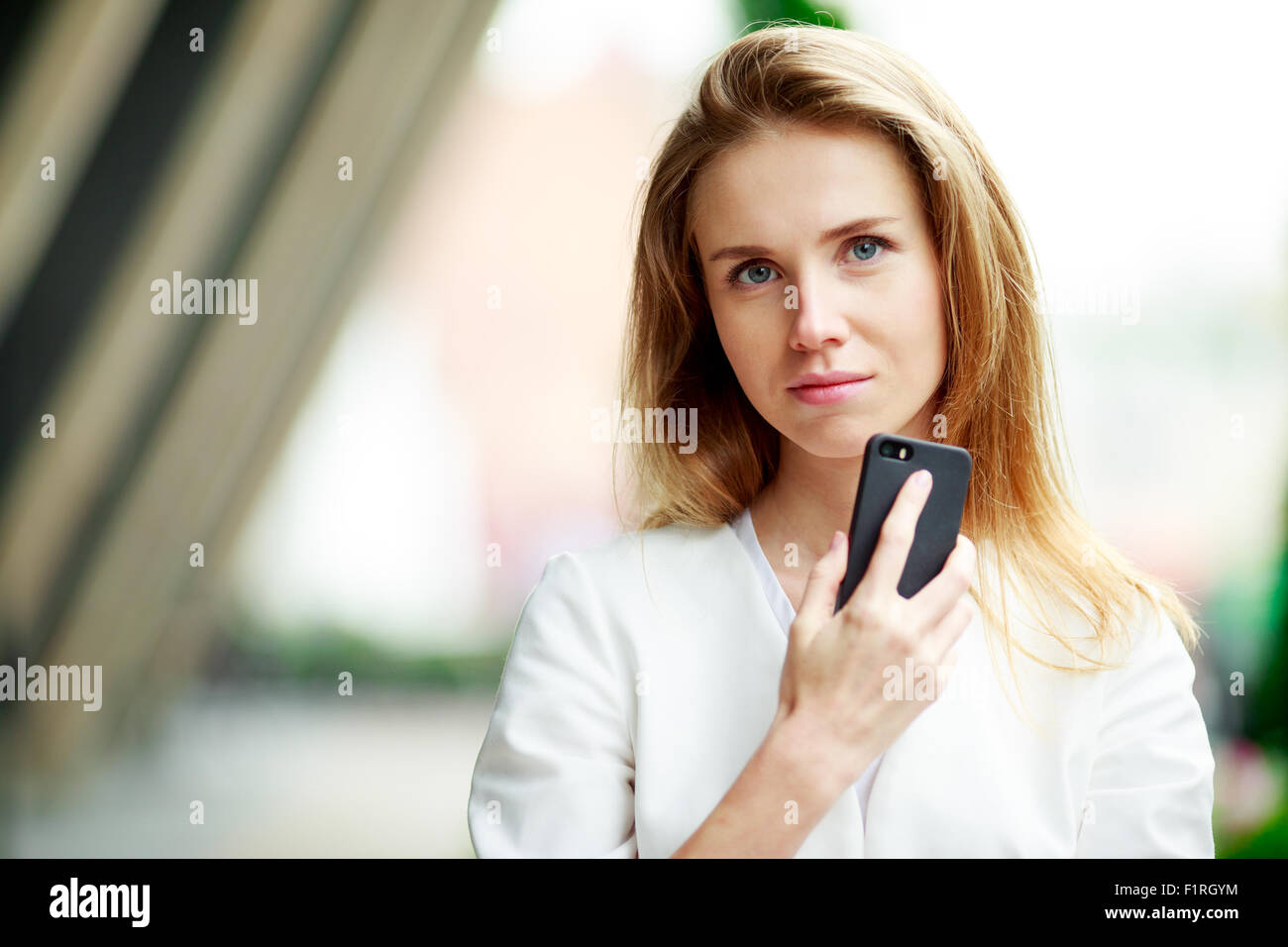 Beautiful casual woman with cell phone Stock Photo - Alamy