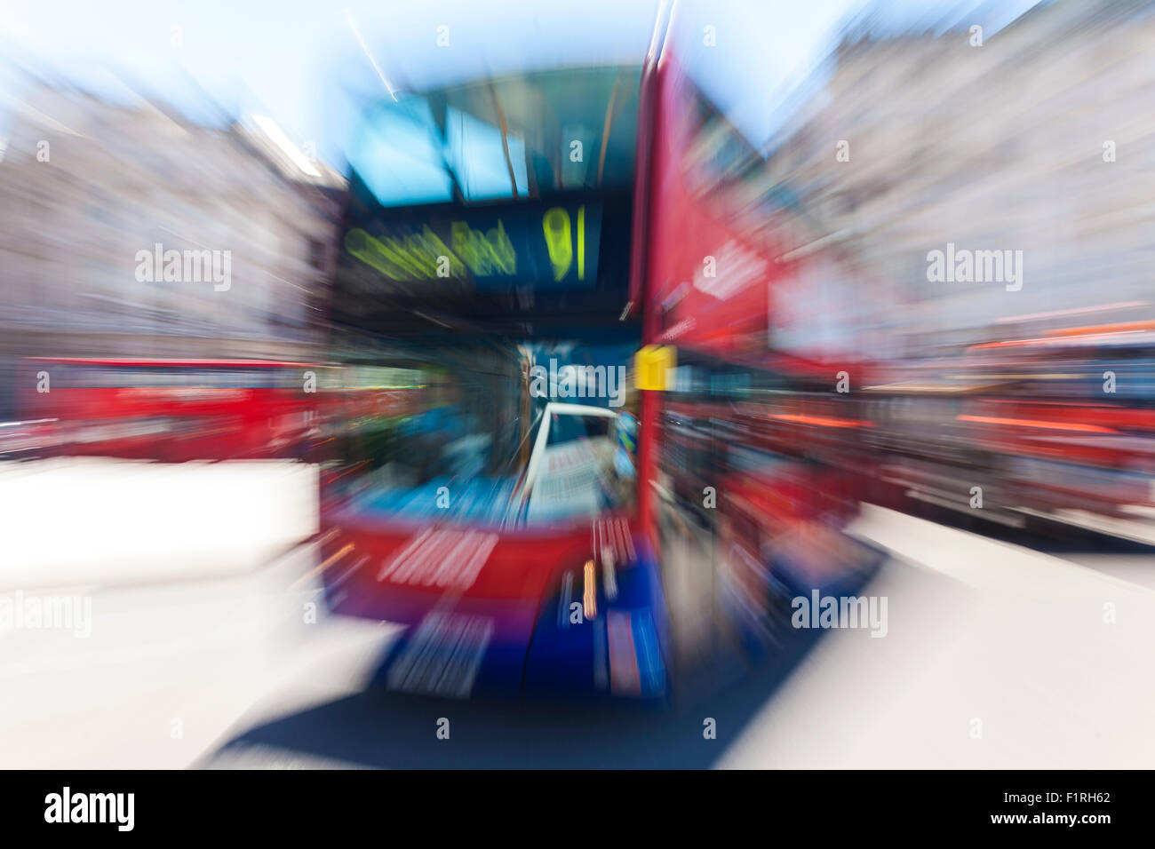Motion blurred zoomed photograph of a red London double decker bus ...