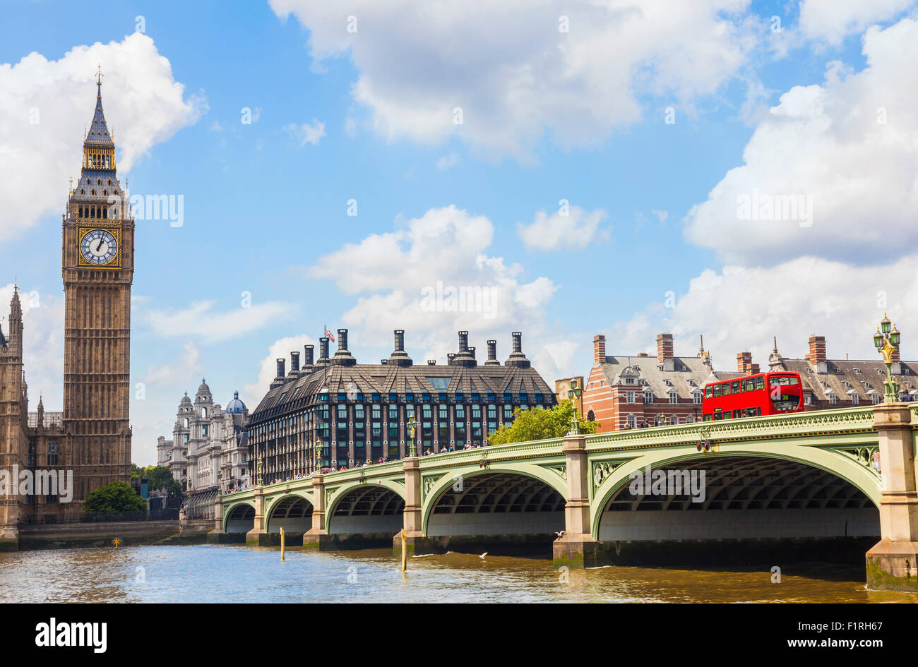 Famous landmark clock tower known as Big Ben and red double decker bus ...