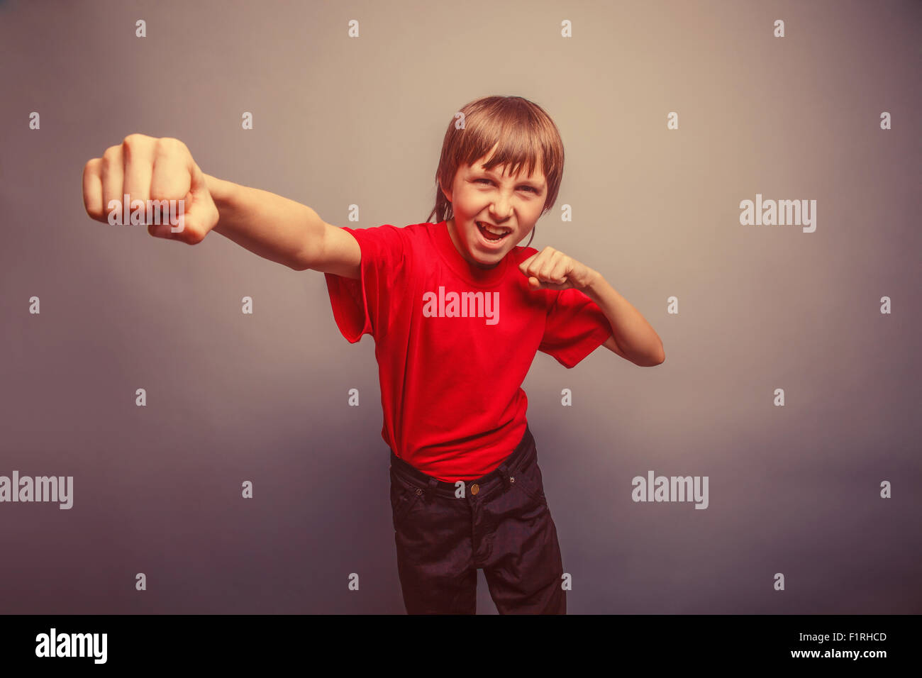 European-looking boy of ten years shows a fist, anger, danger, m Stock ...