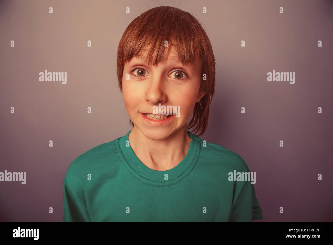 European-looking boy of ten years surprise smile on a gray backg Stock ...