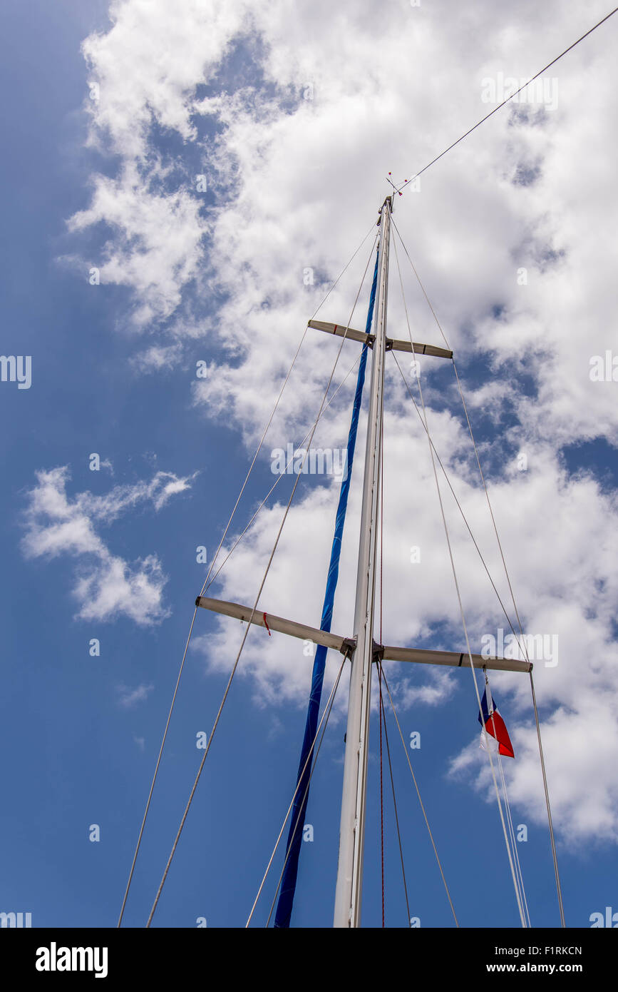 sailboat mast against a cloudy blue sky Stock Photo - Alamy