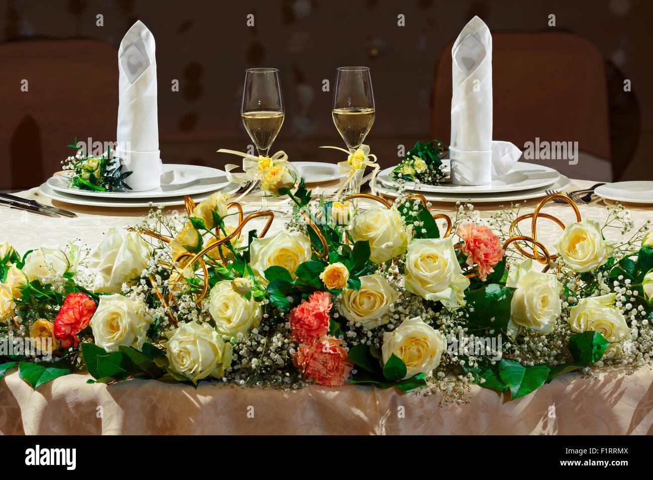 Decorated wedding table for newlyweds with two glasses of champagne ...