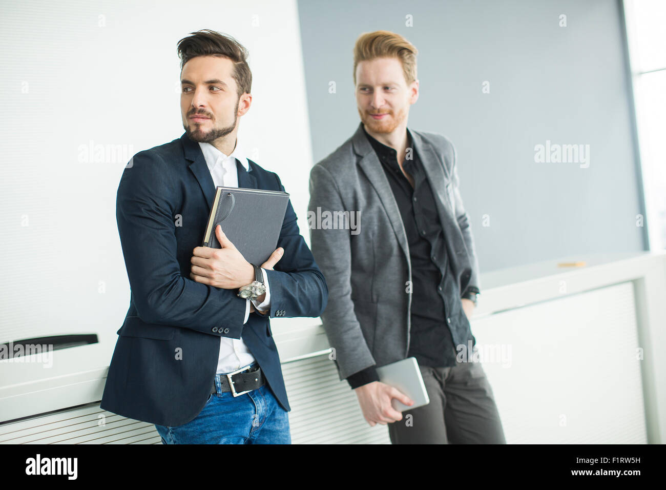 Young men in the office Stock Photo - Alamy
