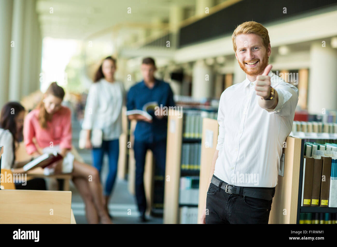 Young man in the library Stock Photo - Alamy