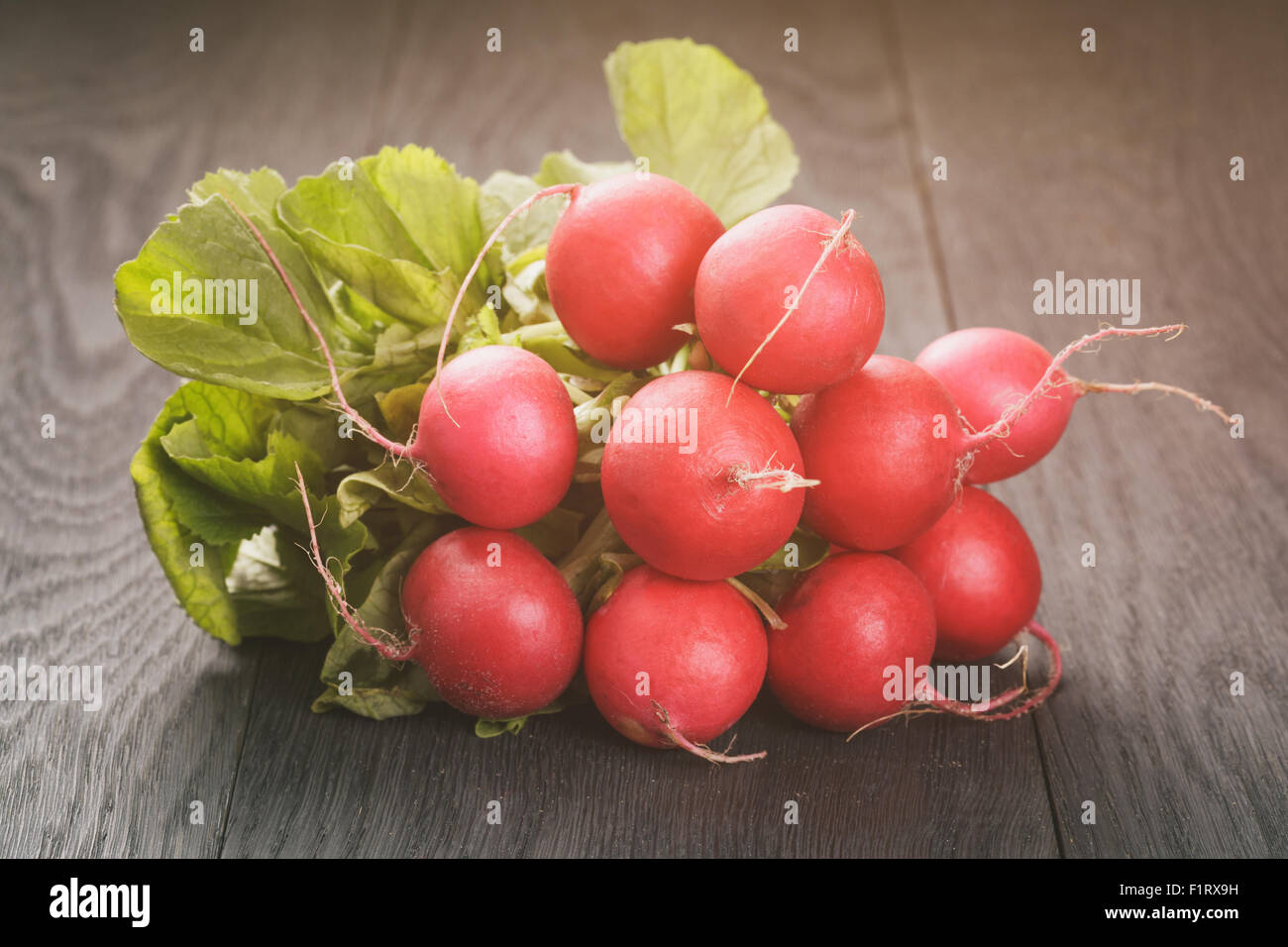 fresh radishes on old wooden table Stock Photo - Alamy