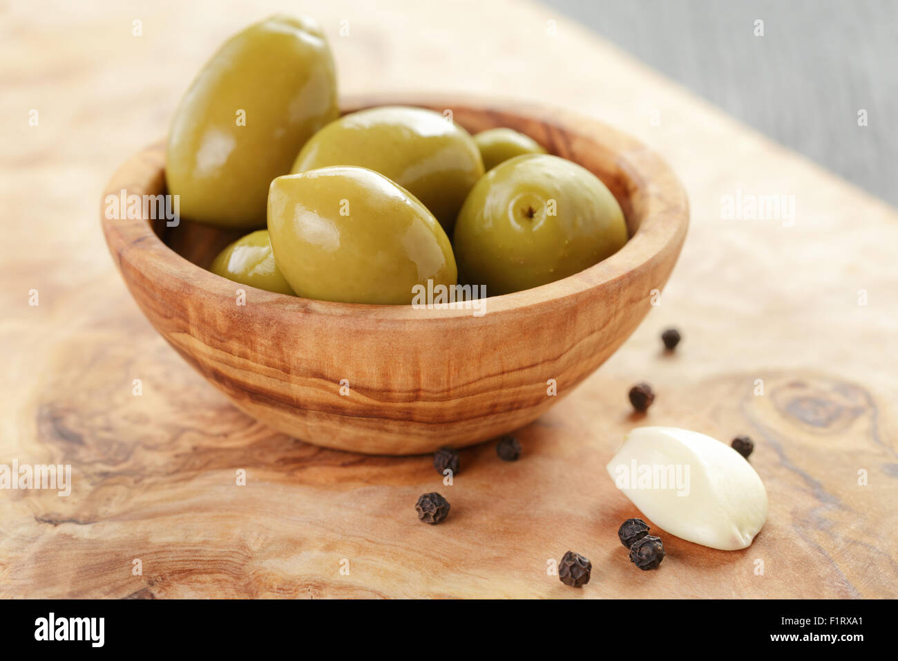 green huge olives on wood table Stock Photo - Alamy