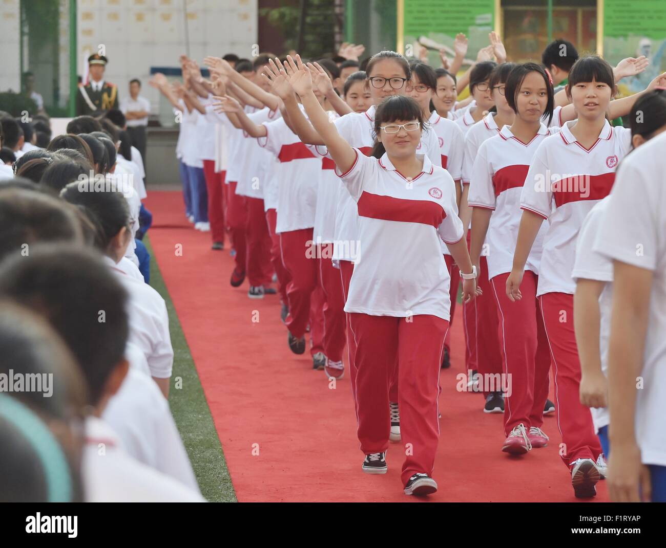 Beijing, China. 7th Sep, 2015. Newly-enrolled students wave hands as ...