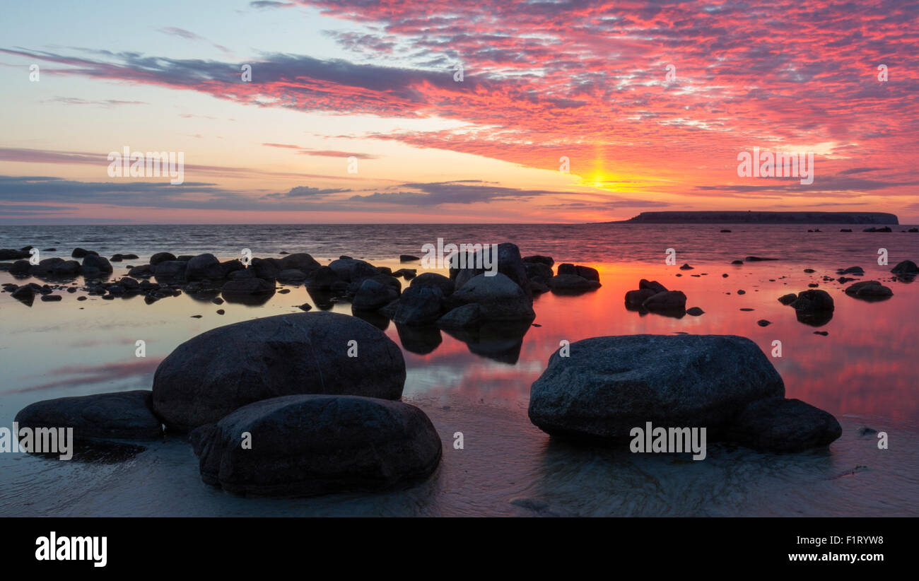 Sunset at the Coast of Eksta on Gotland, Sweden. Warm red colors ...