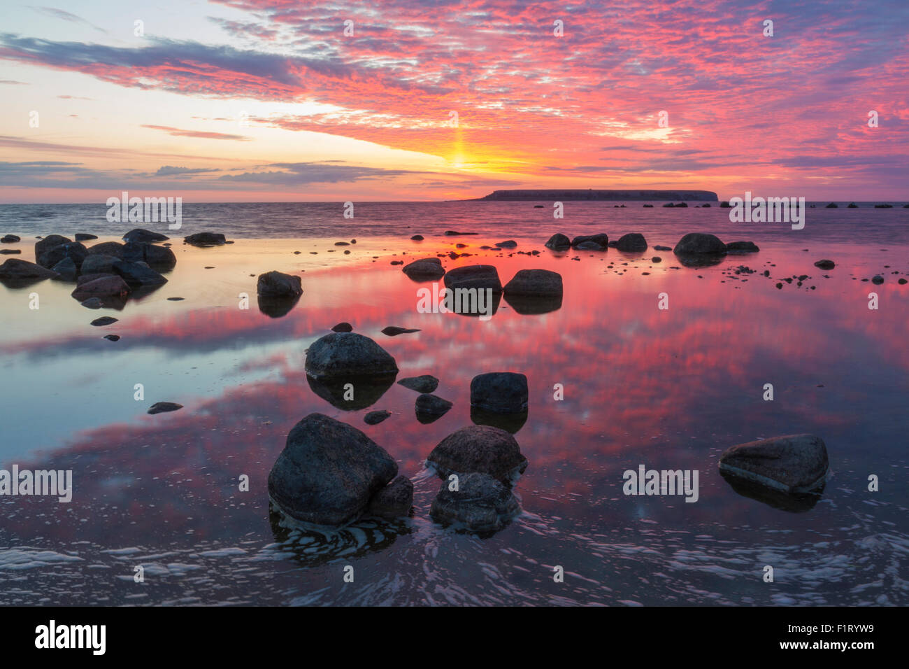 Sunset at the Coast of Eksta on Gotland, Sweden. Warm red colors ...
