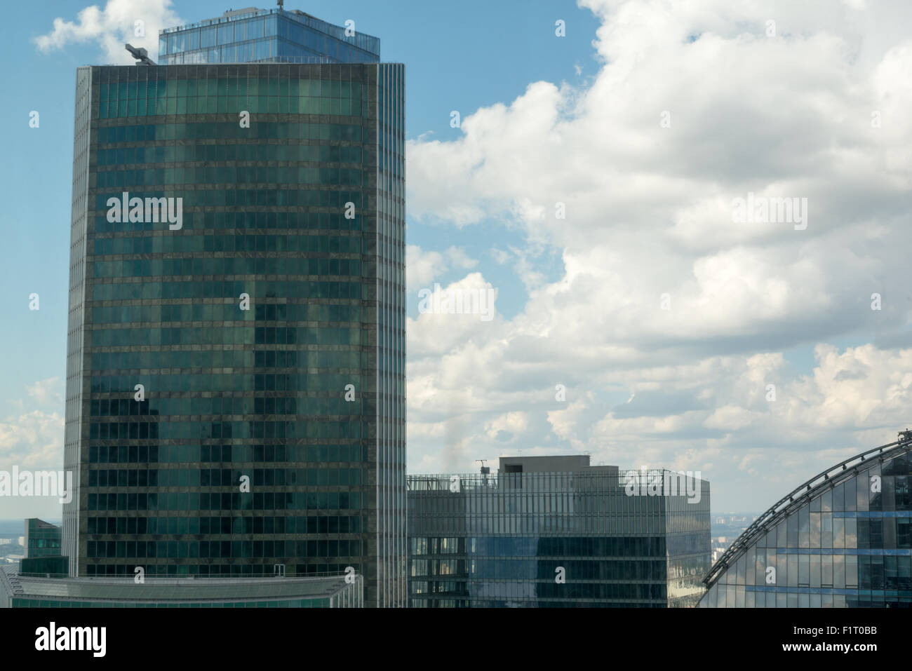 High-rise buildings on blue sky with clouds Stock Photo - Alamy