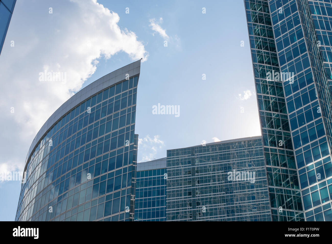 High-rise buildings on blue sky with clouds Stock Photo - Alamy