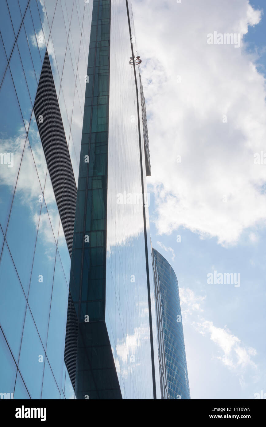 Part of skyscraper on blue sky with clouds Stock Photo - Alamy