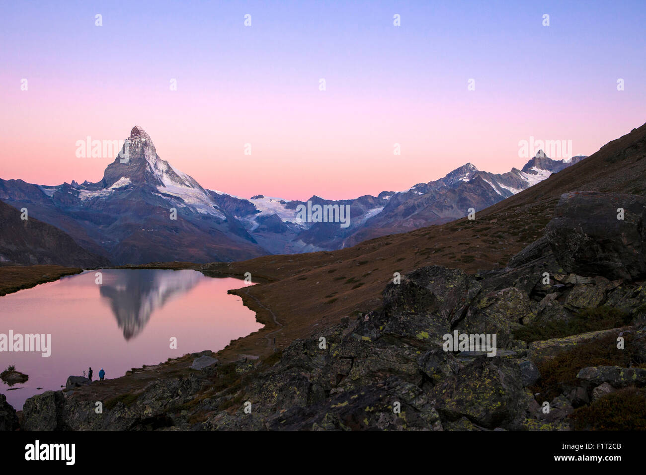 Pink sky at sunrise on the Matterhorn reflected in Stellisee, Zermatt ...