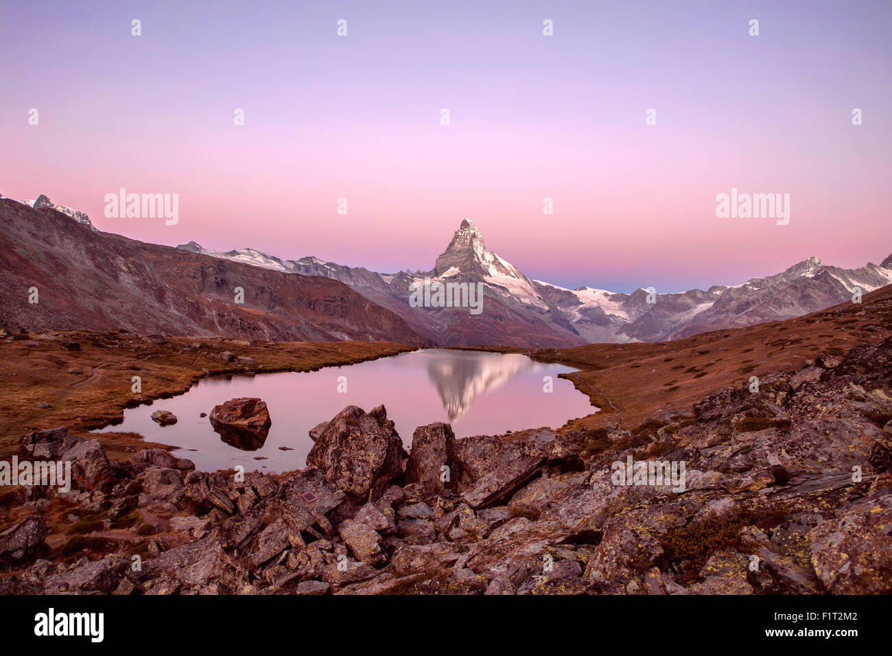 Pink sky at sunrise on the Matterhorn reflected in Stellisee, Zermatt ...