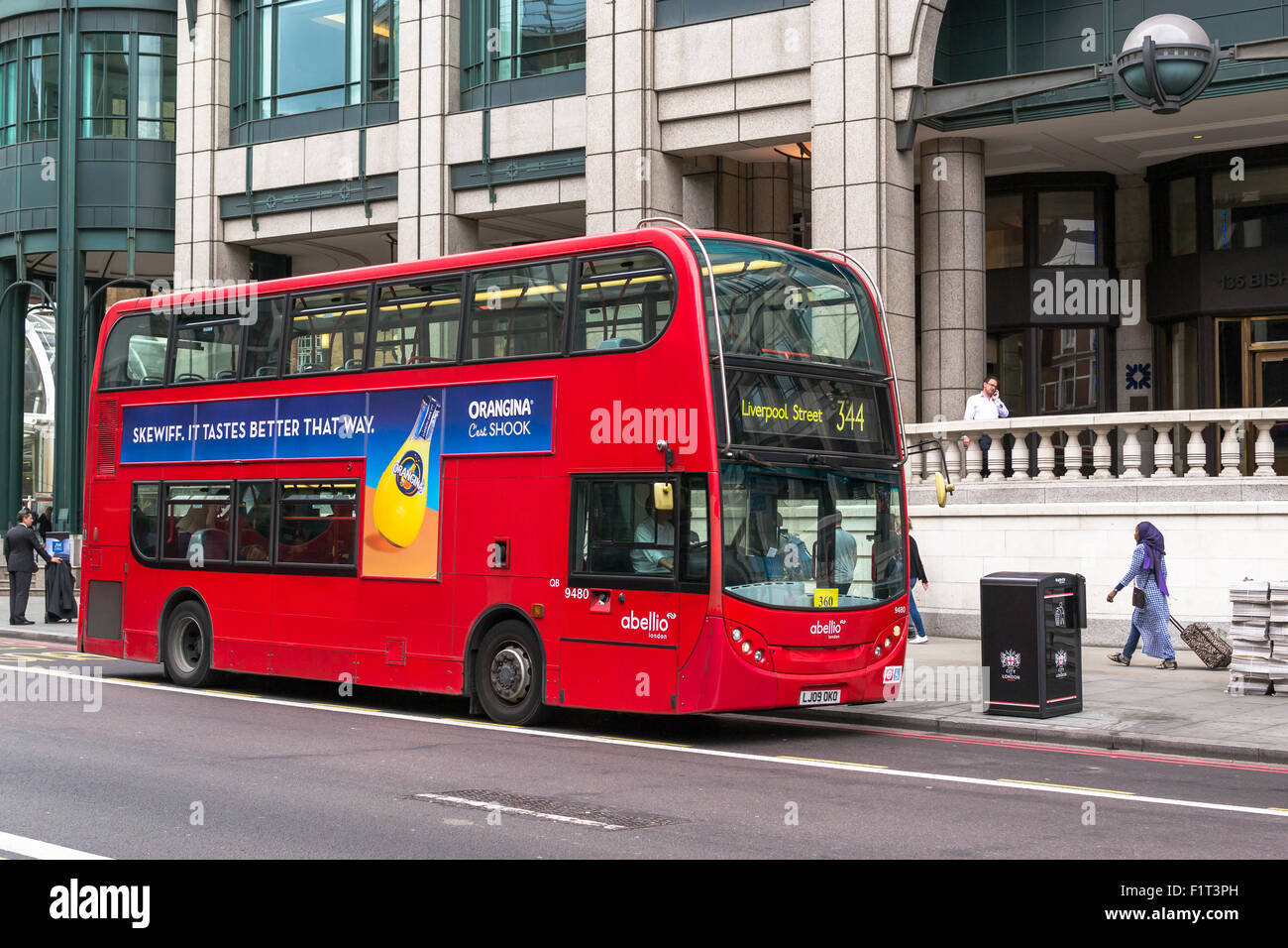 Modern red bus in motion on Bishopsgate Road in London during the ...