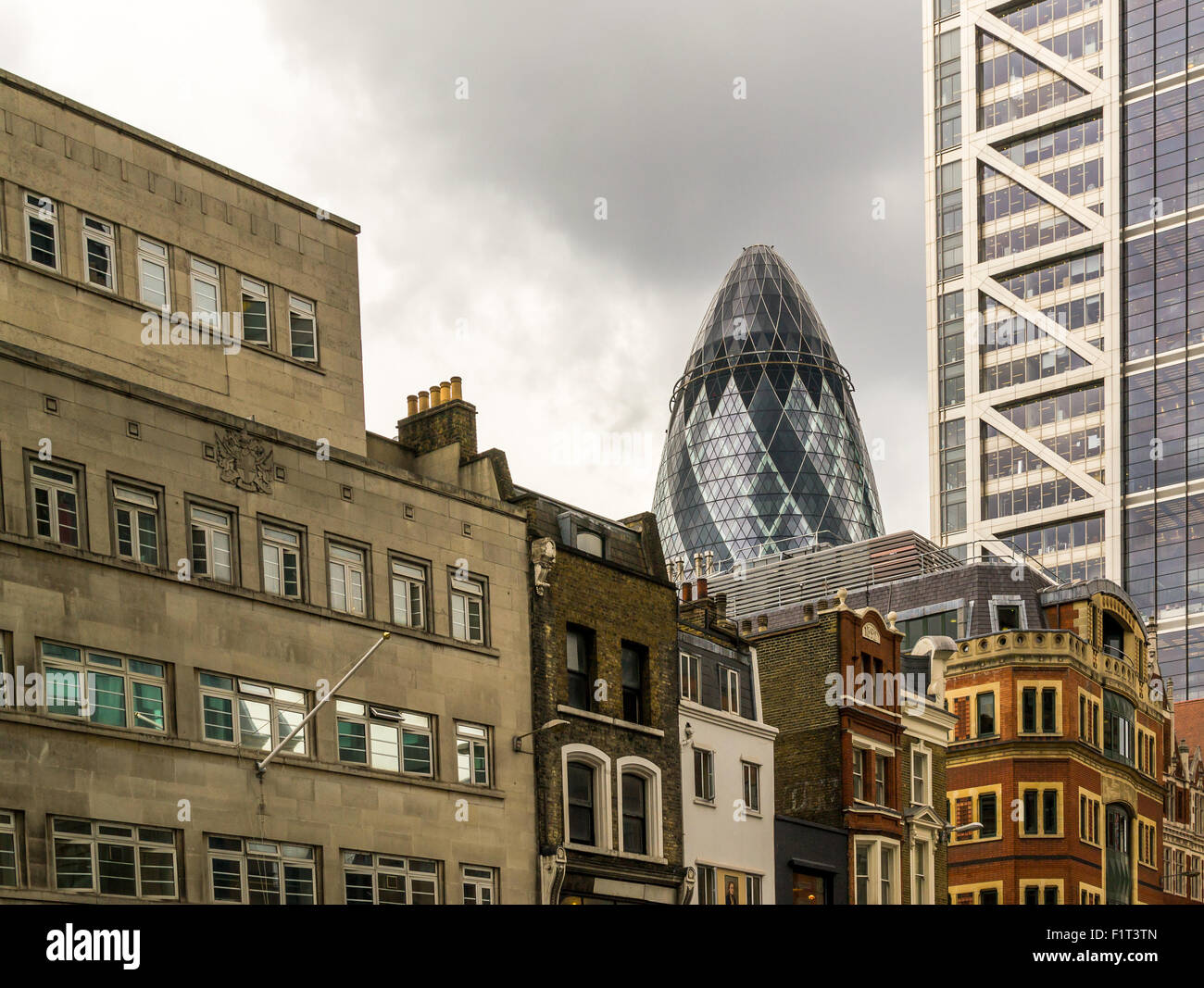 Famous London landmark building the Gherkin with classical buildings in ...