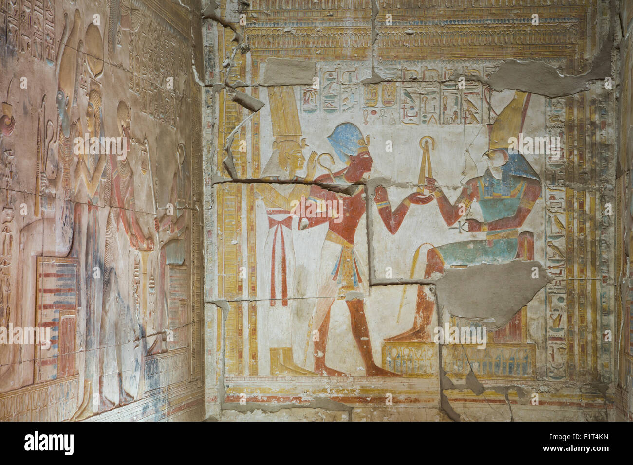 Bas relief of Pharaoh Seti I making an offering to the seated God Horus ...