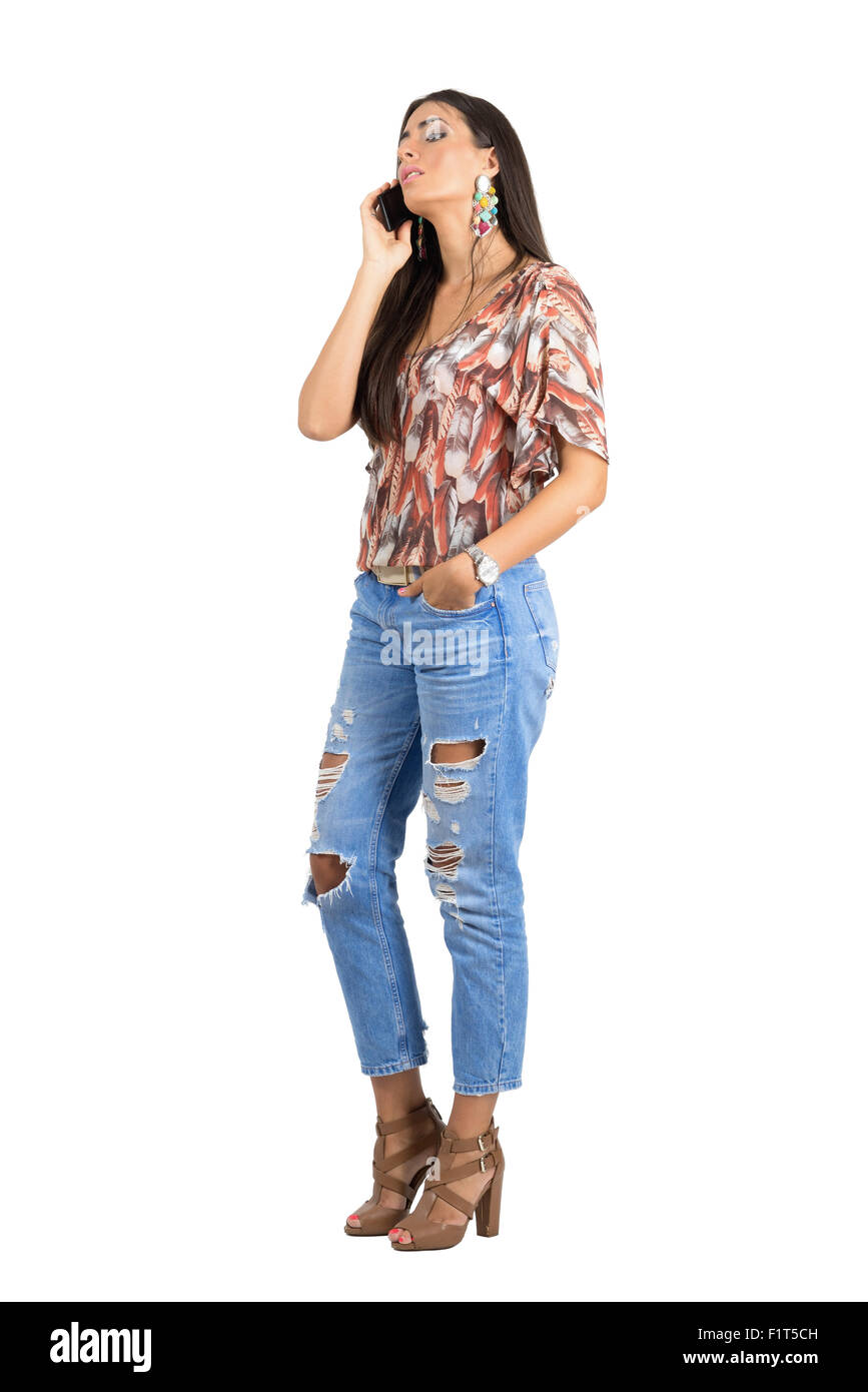 Relaxed young Indian woman with head leaned back talking on the ...