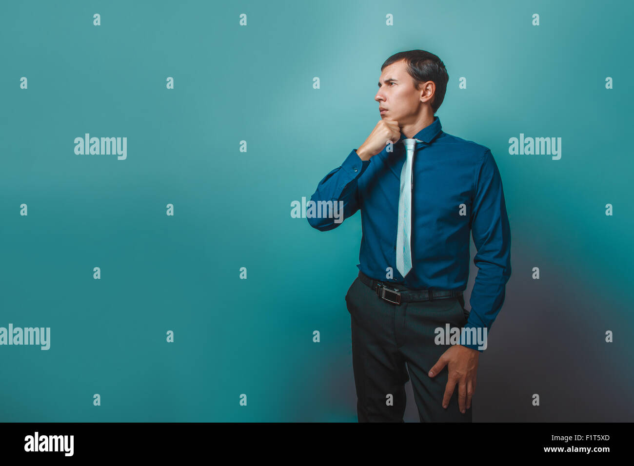 a man of European appearance thirty years thinking hand on chin Stock ...