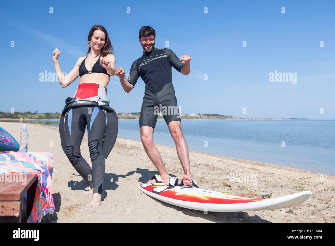 Two surfers on beach Stock Photo - Alamy