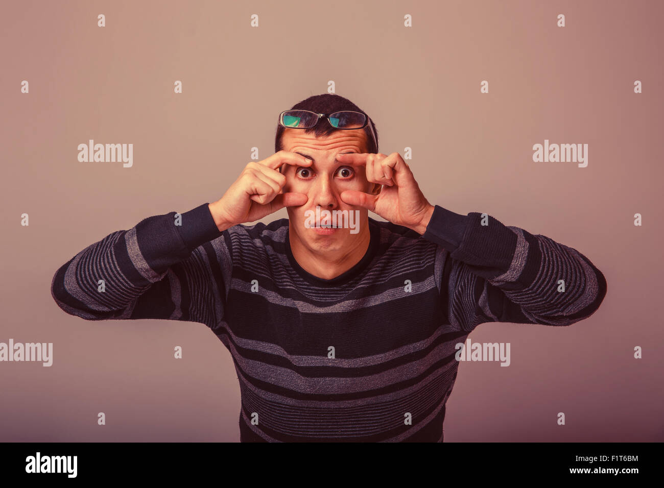 European-looking male of about thirty brunet stretches eyes with Stock ...