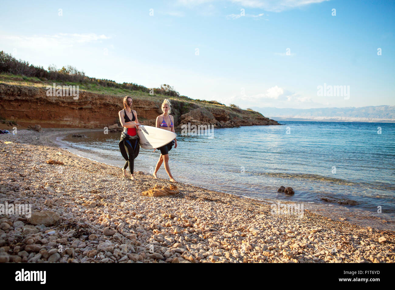 Female surfers on beach Stock Photo - Alamy