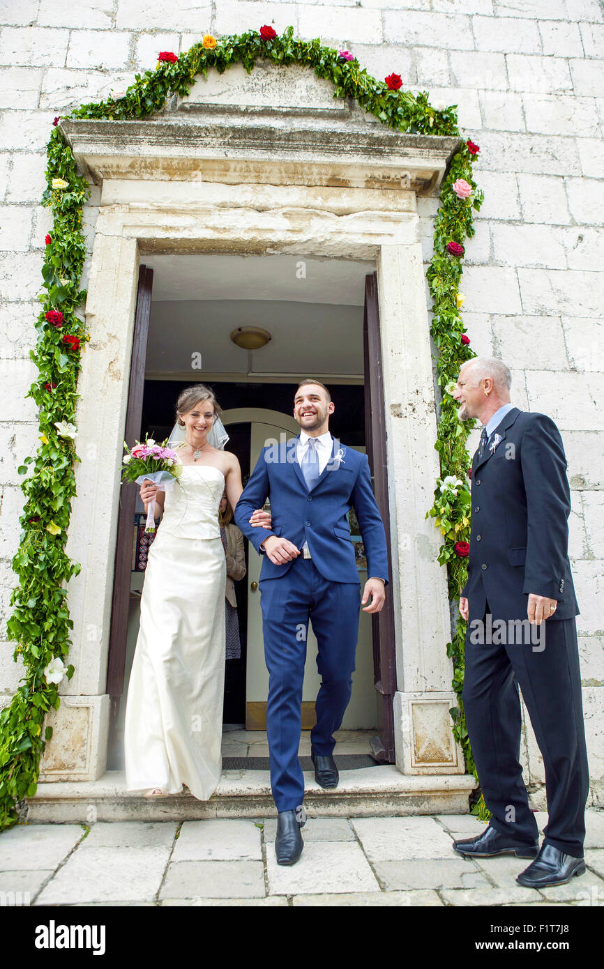 Bride and groom leaving chapel Stock Photo - Alamy
