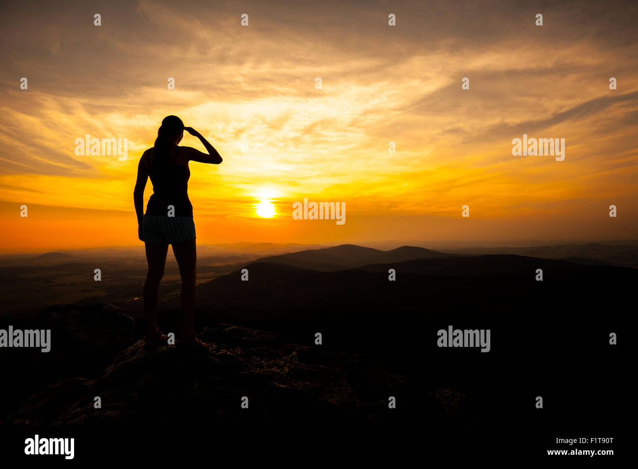 Silhouette of young woman in sunset Stock Photo - Alamy