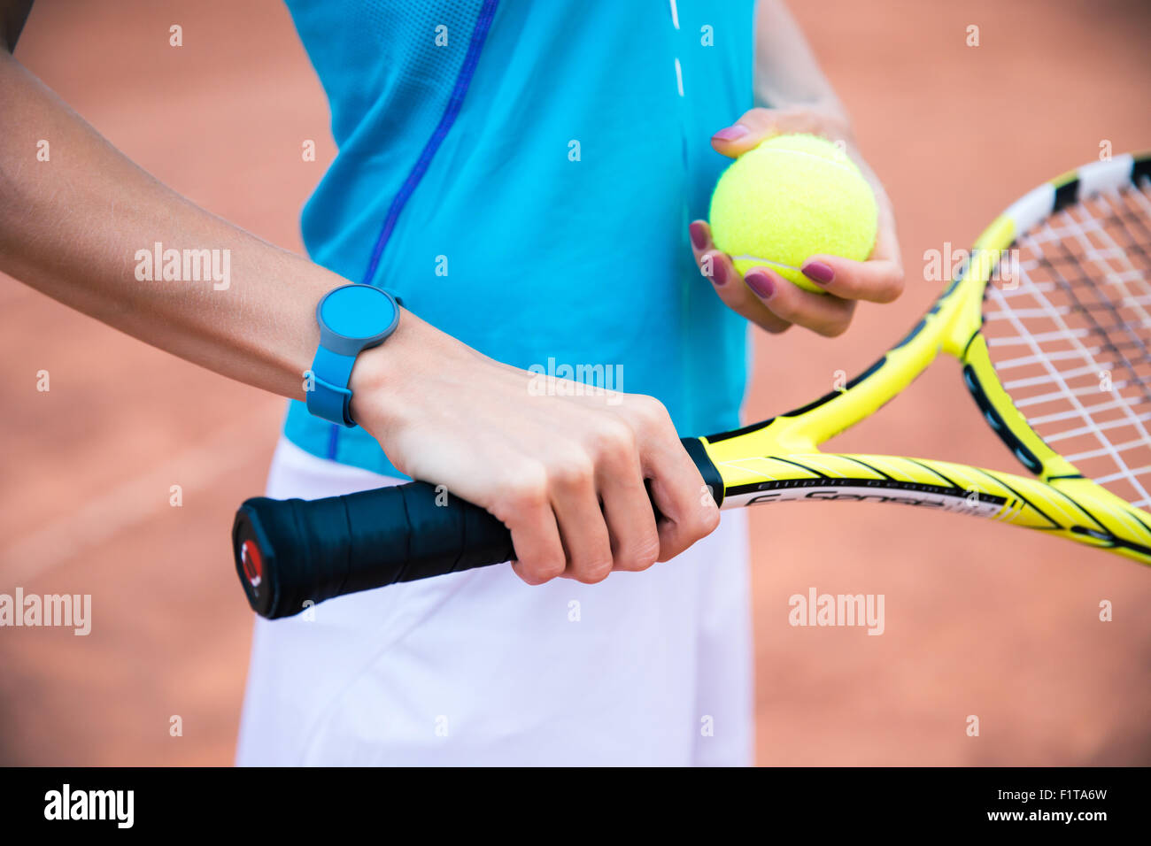 Closeup portrait of a female tennis player holding racket and ball ...