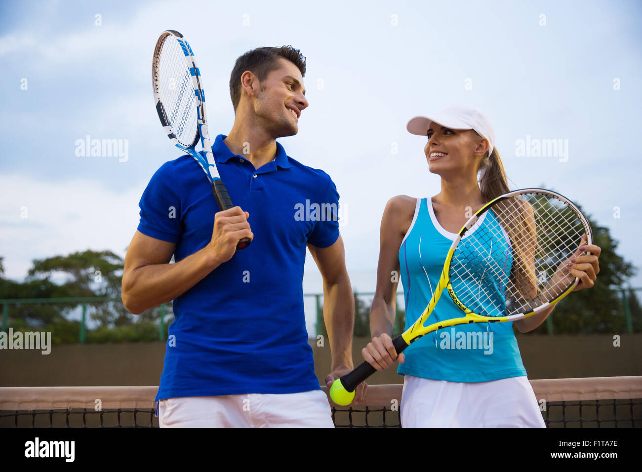 Couple of tennis players talking at the court after a match Stock Photo ...