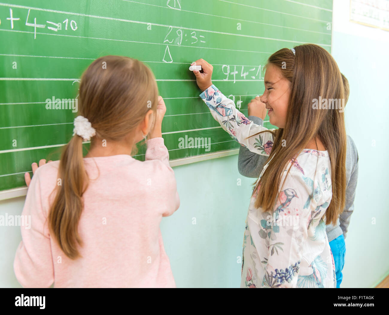 Teacher and student at the blackboard, math class Stock Photo - Alamy