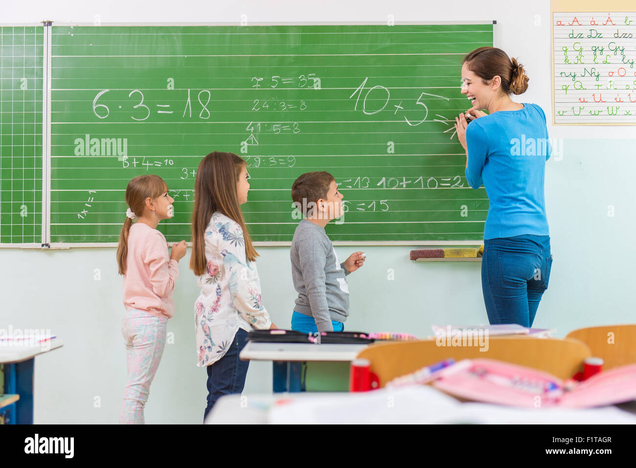 Teacher and student at the blackboard, math class Stock Photo - Alamy