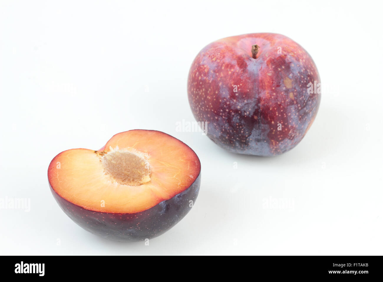 Closeup of ripe plums isolated on white Stock Photo - Alamy