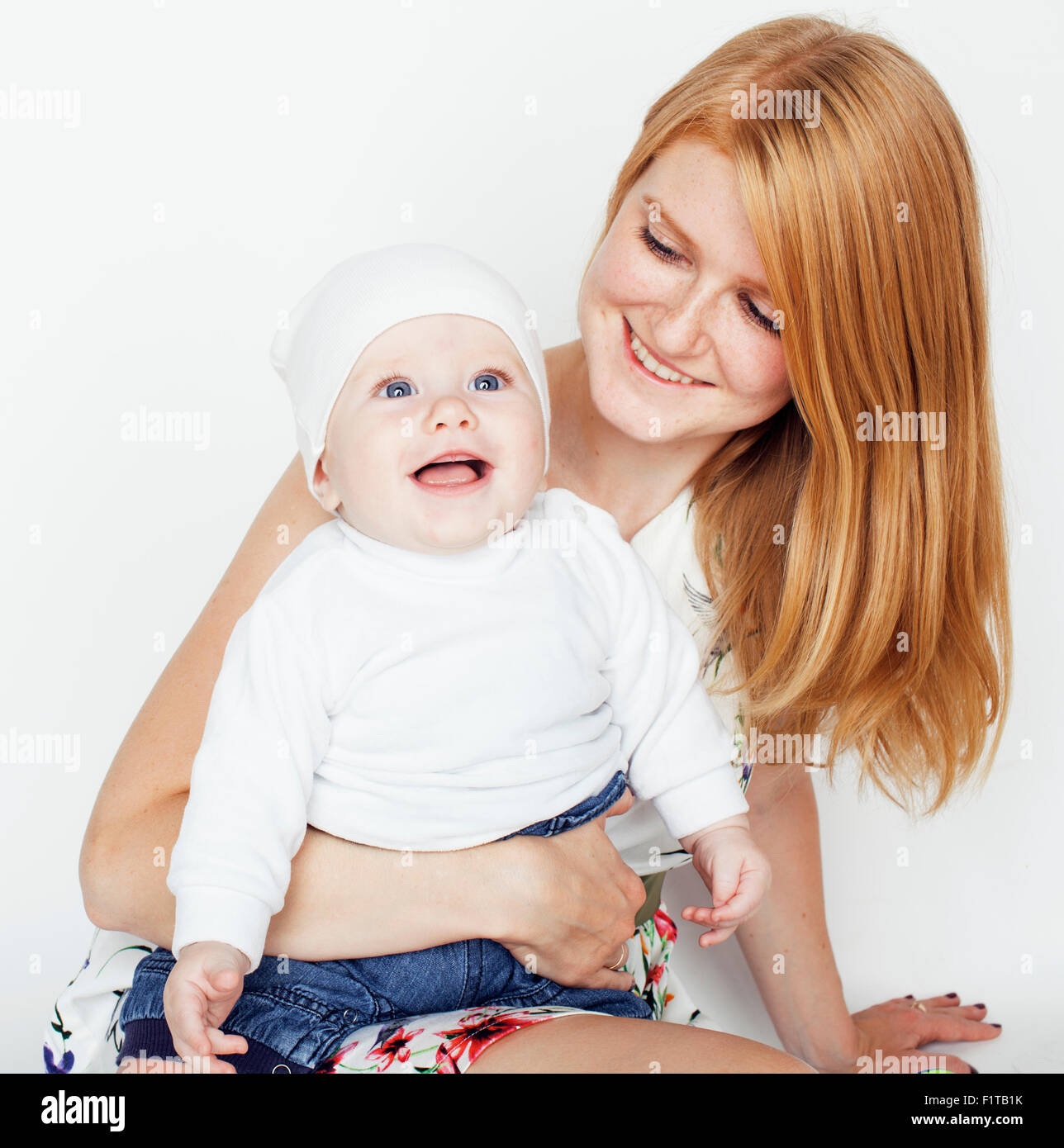 young beauty mother with baby, red head happy family isolated Stock ...