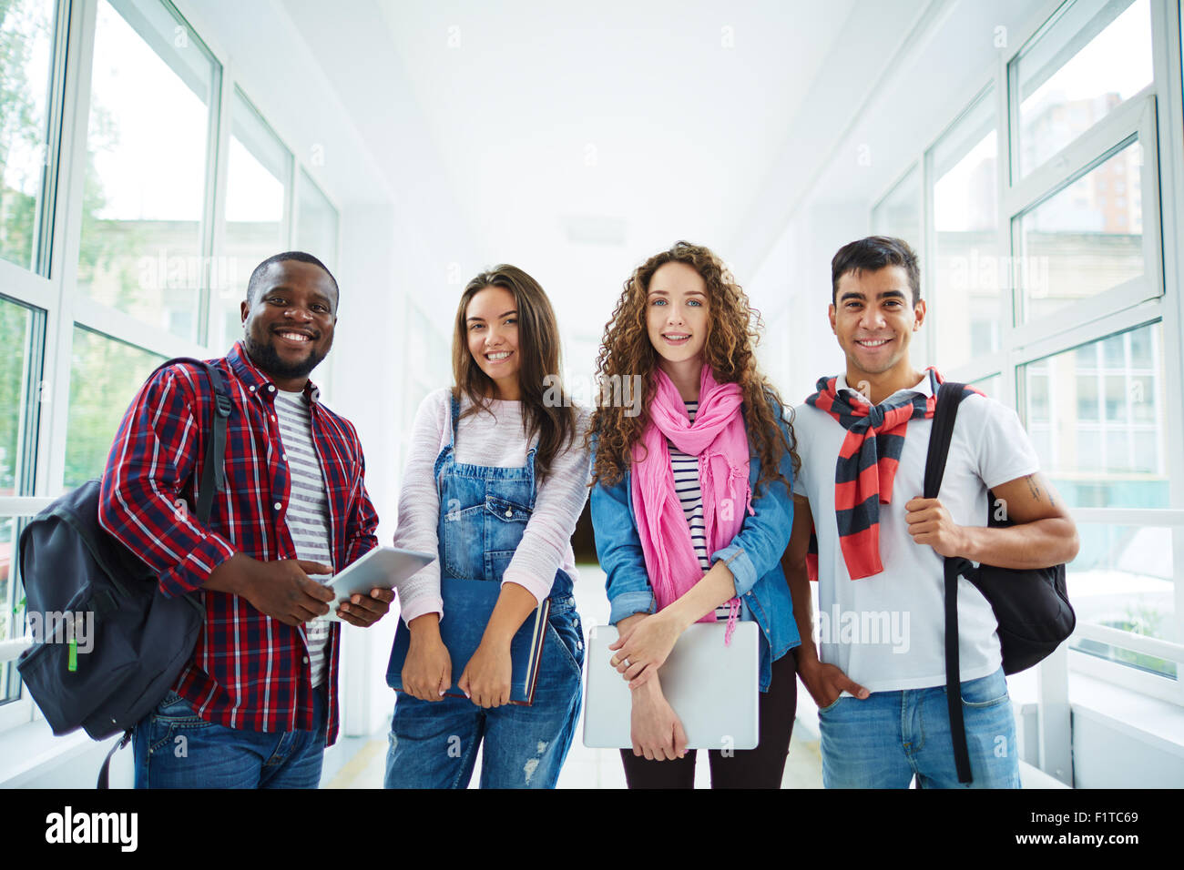 Friendly students of various ethnicities looking at camera Stock Photo ...