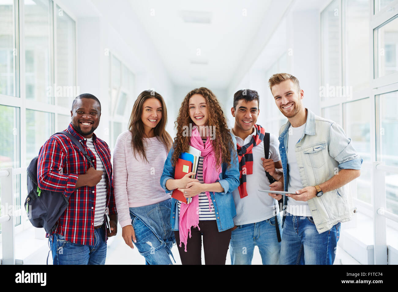 Friendly college learners looking at camera with smiles Stock Photo - Alamy