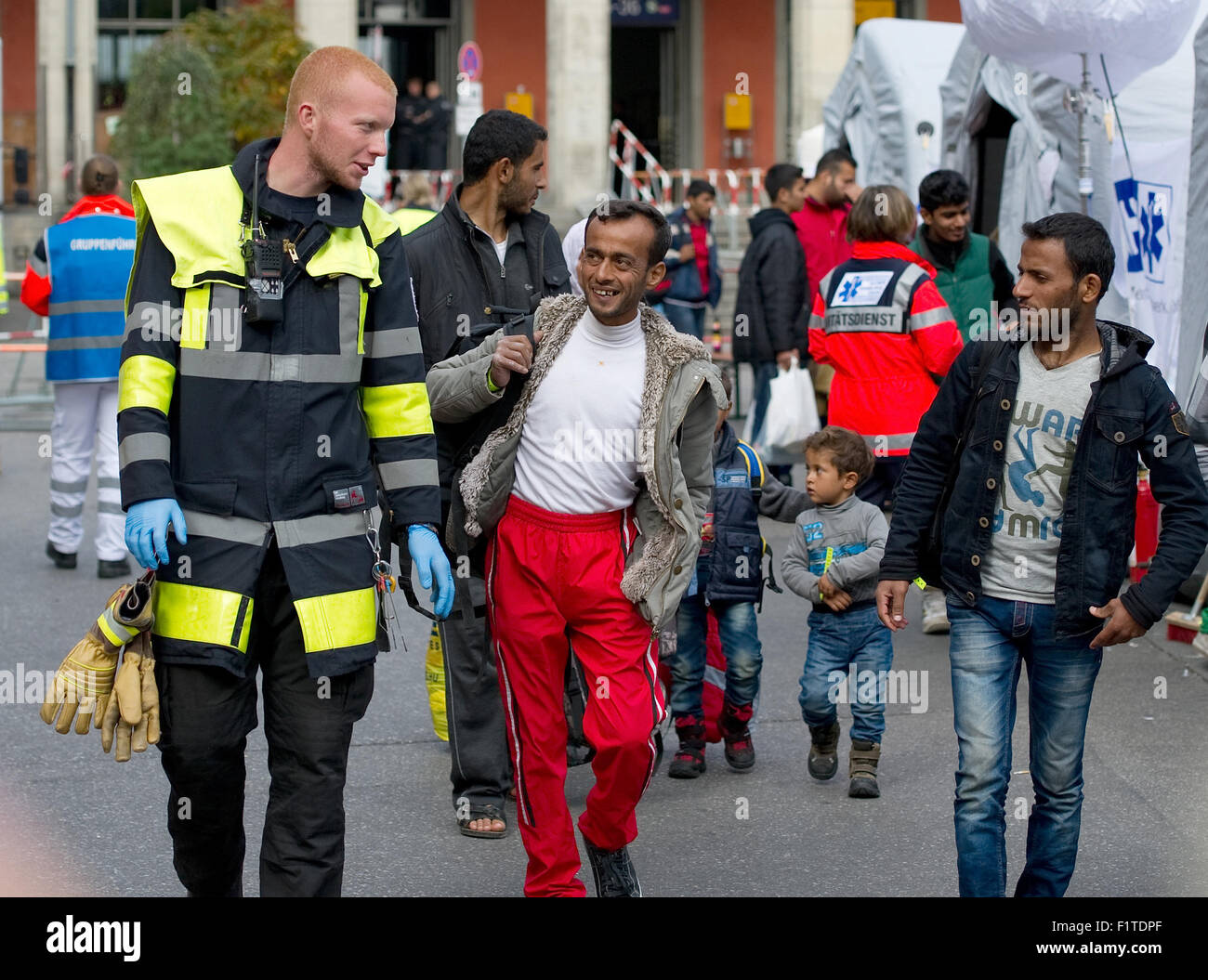 Refugees wait at main train station to be taken to the refugee ...