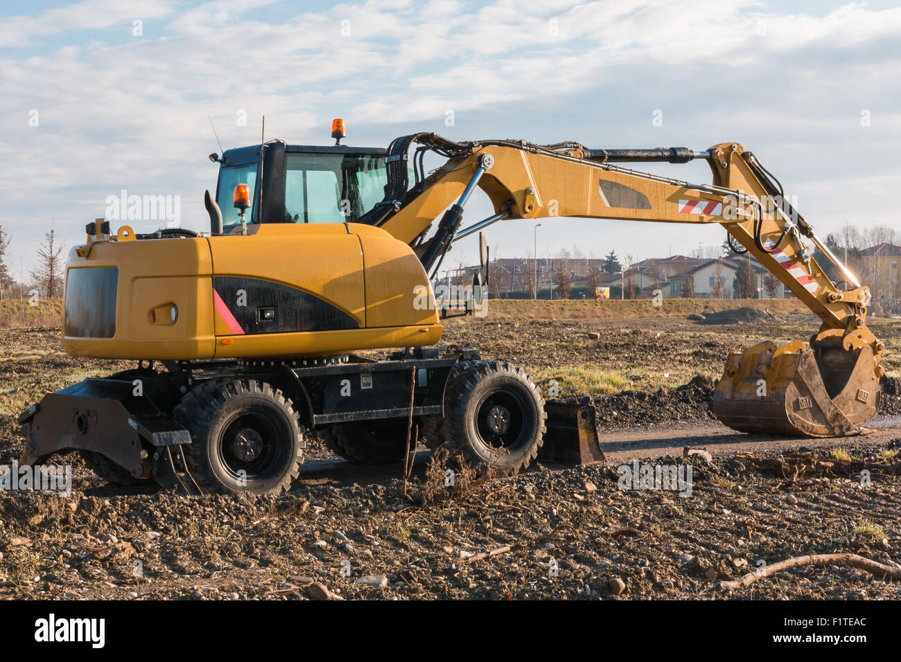 yellow excavator with muddy shovel at construction area Stock Photo - Alamy