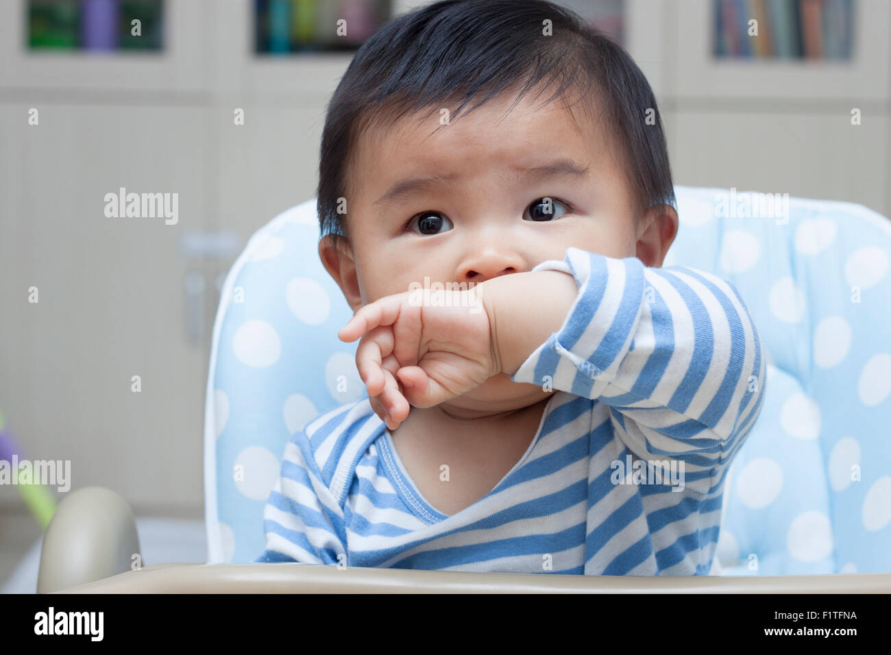 Cute Chinese baby boy sitting in baby chair Stock Photo - Alamy