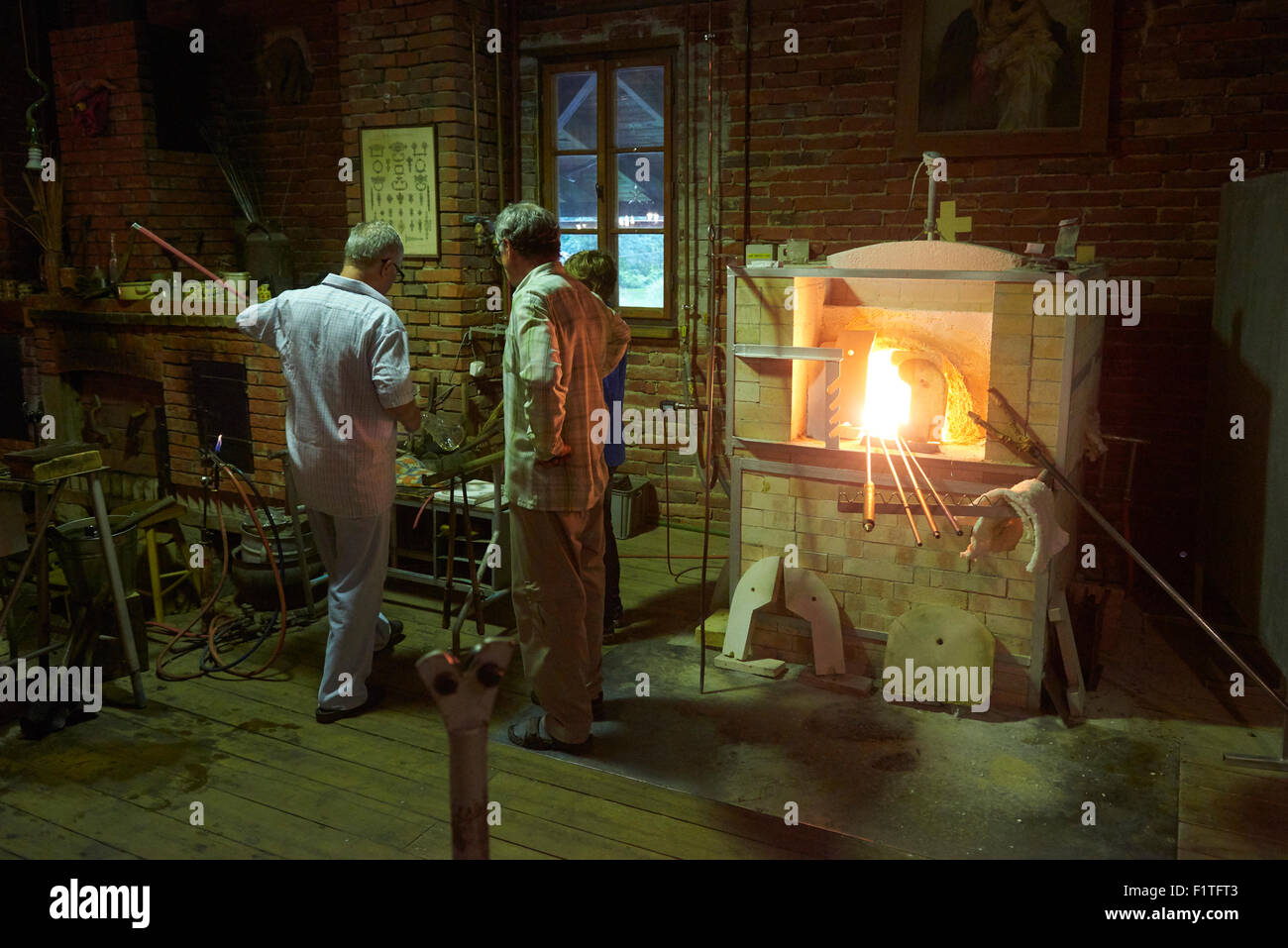 Glassmakers, Glassblowers forming molten glass, glass factory ...