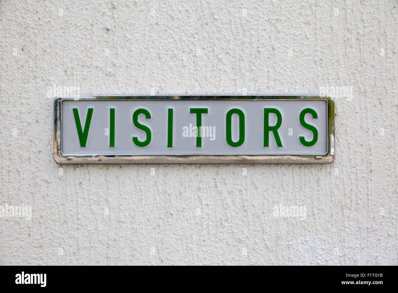 sign with the inscription visitors on wall Stock Photo - Alamy