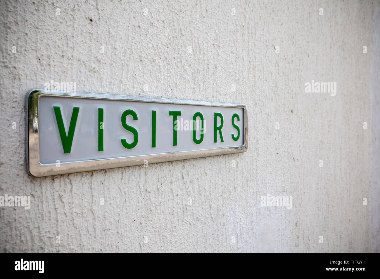 sign with the inscription visitors on wall Stock Photo - Alamy