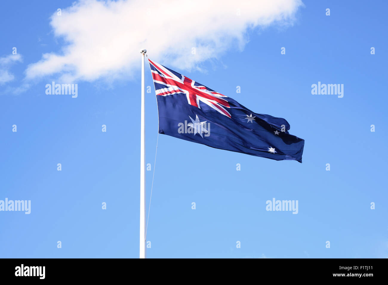 Australian flag over beautiful blue sky with clouds Stock Photo - Alamy